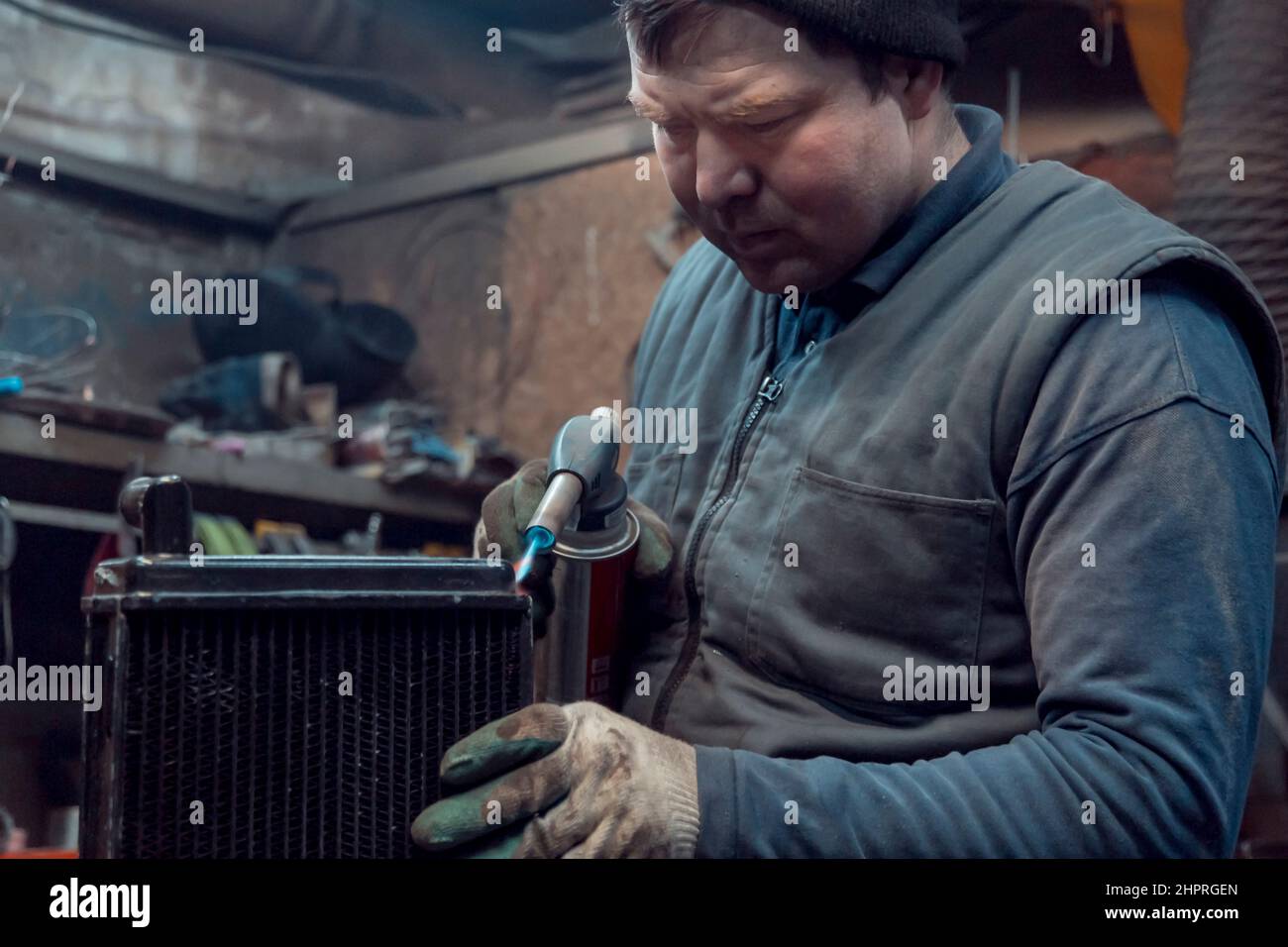 Welding a large car radiator with a gas torch Stock Photo - Alamy
