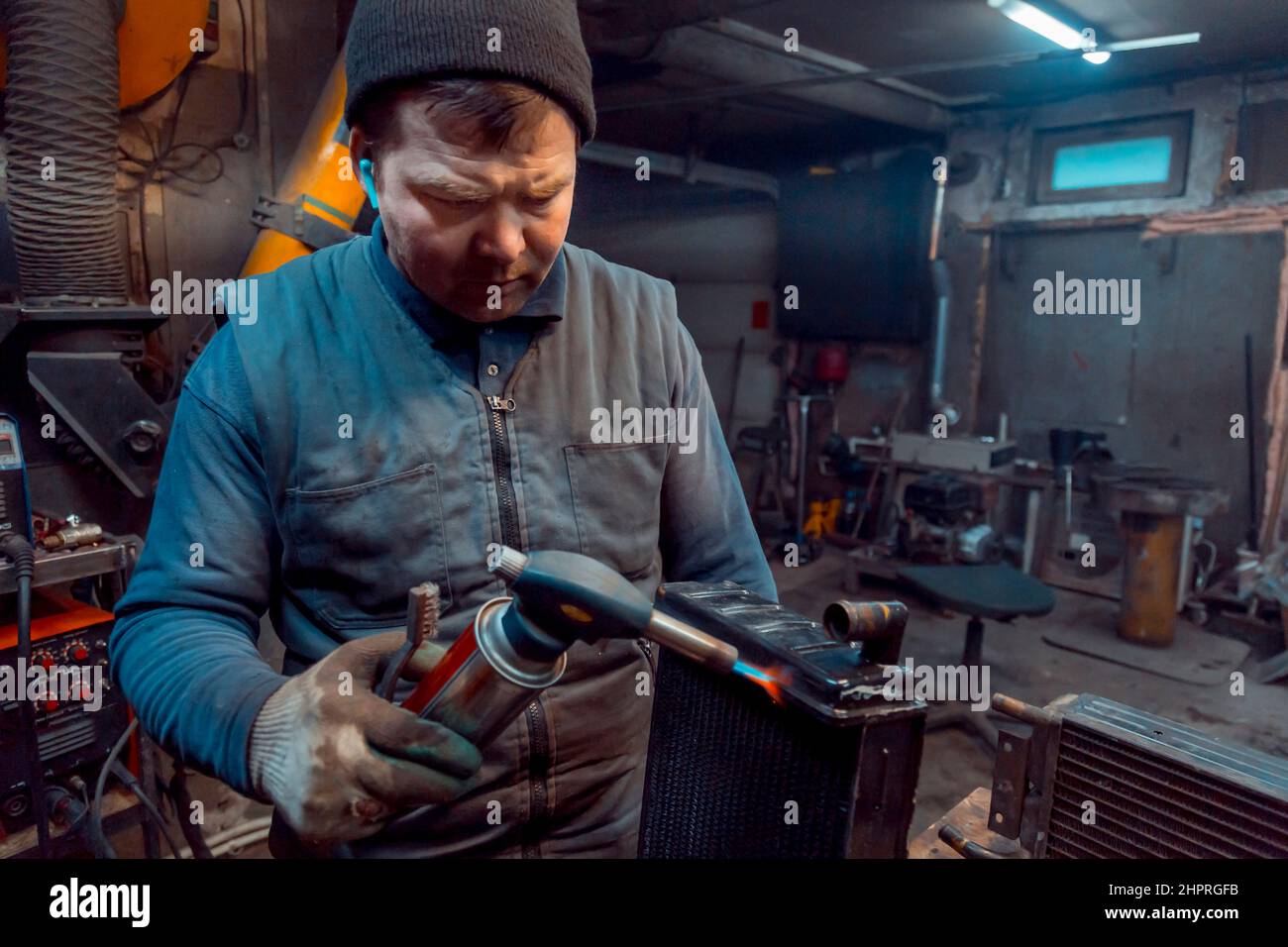 Welding a large car radiator with a gas torch Stock Photo - Alamy