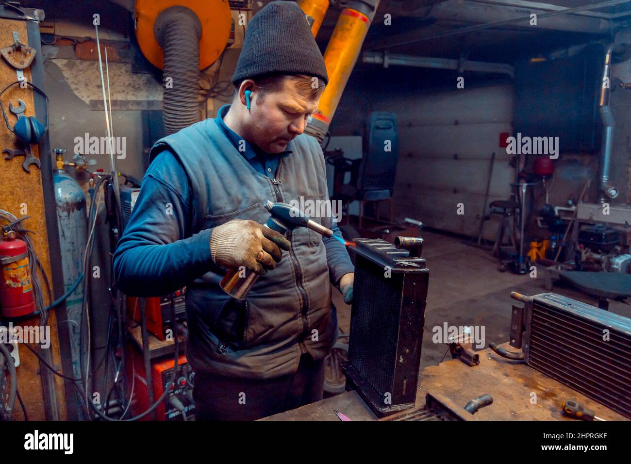 Welding a large car radiator with a gas torch Stock Photo - Alamy