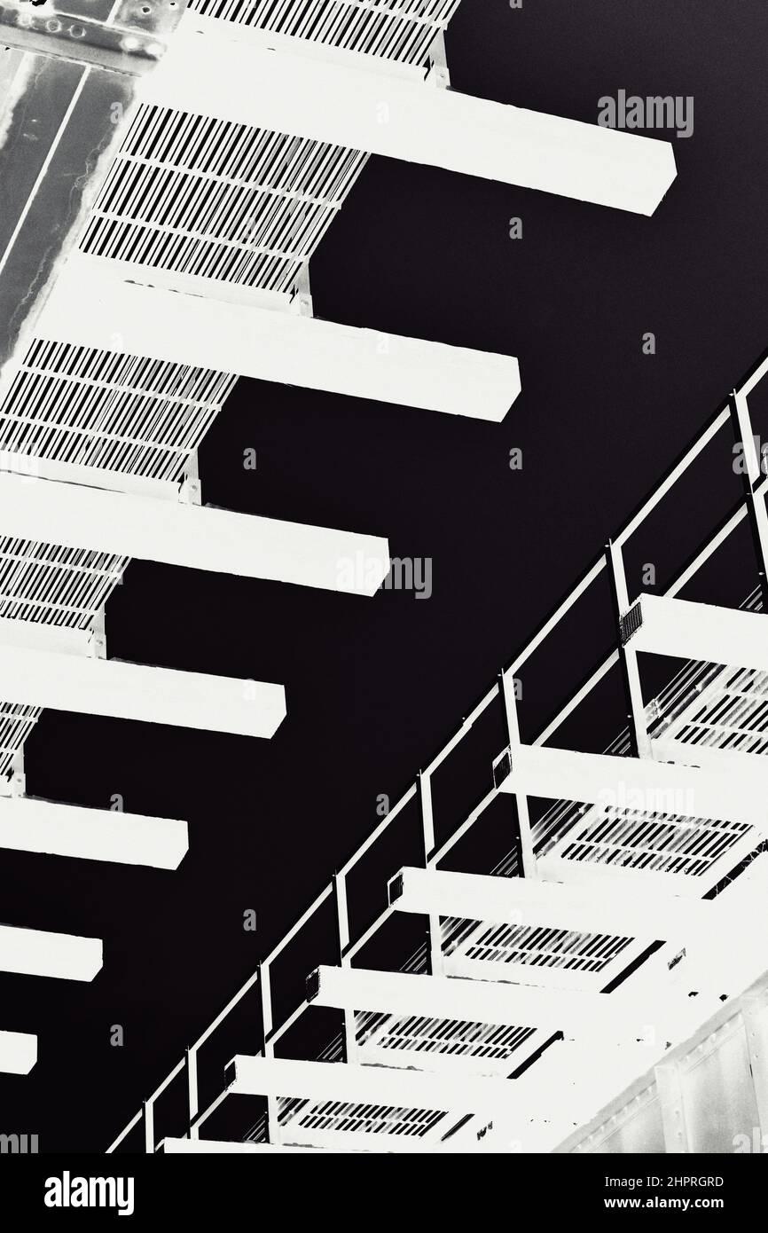 A black and white high contrast view of an overhead train platform ...