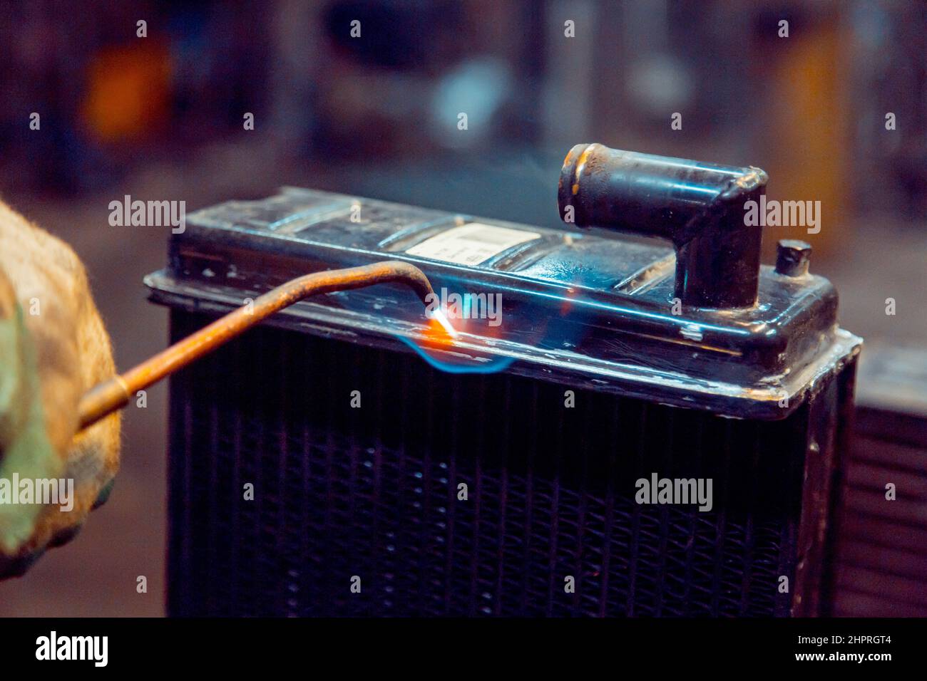 Welding a large car radiator with a gas torch Stock Photo - Alamy