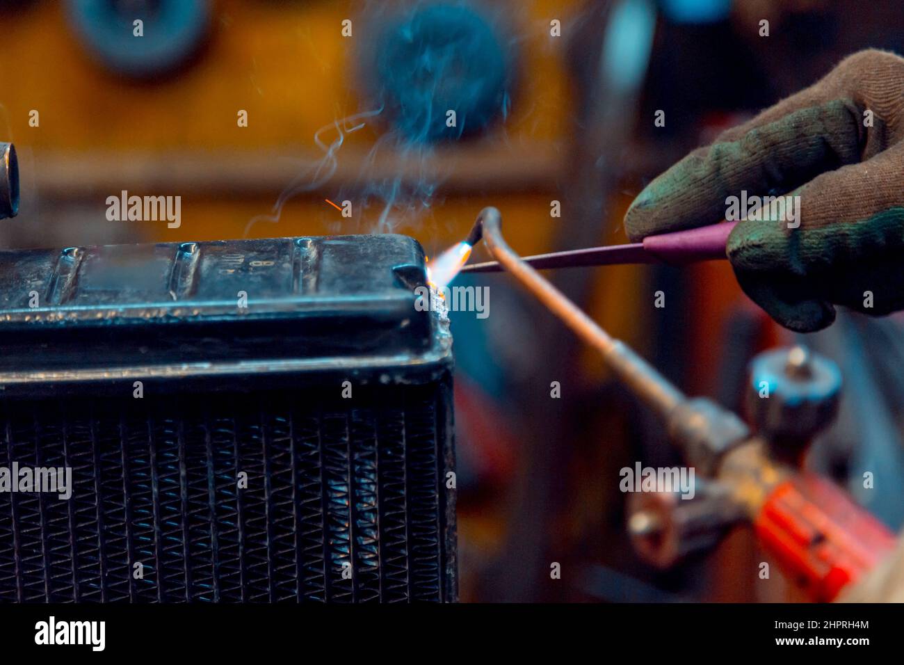 Welding a large car radiator with a gas torch Stock Photo - Alamy