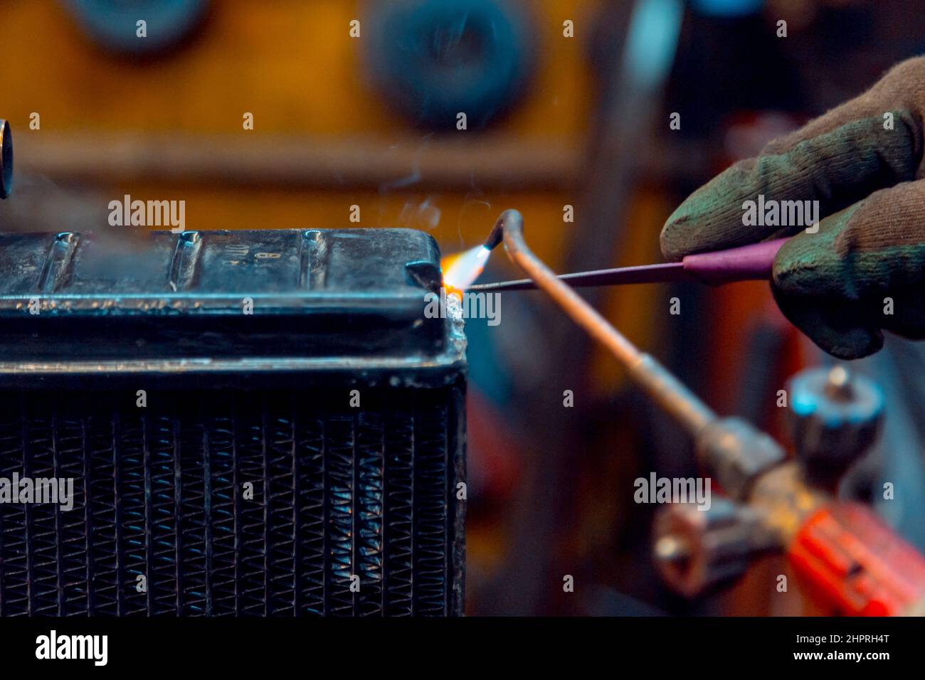 Welding a large car radiator with a gas torch Stock Photo - Alamy