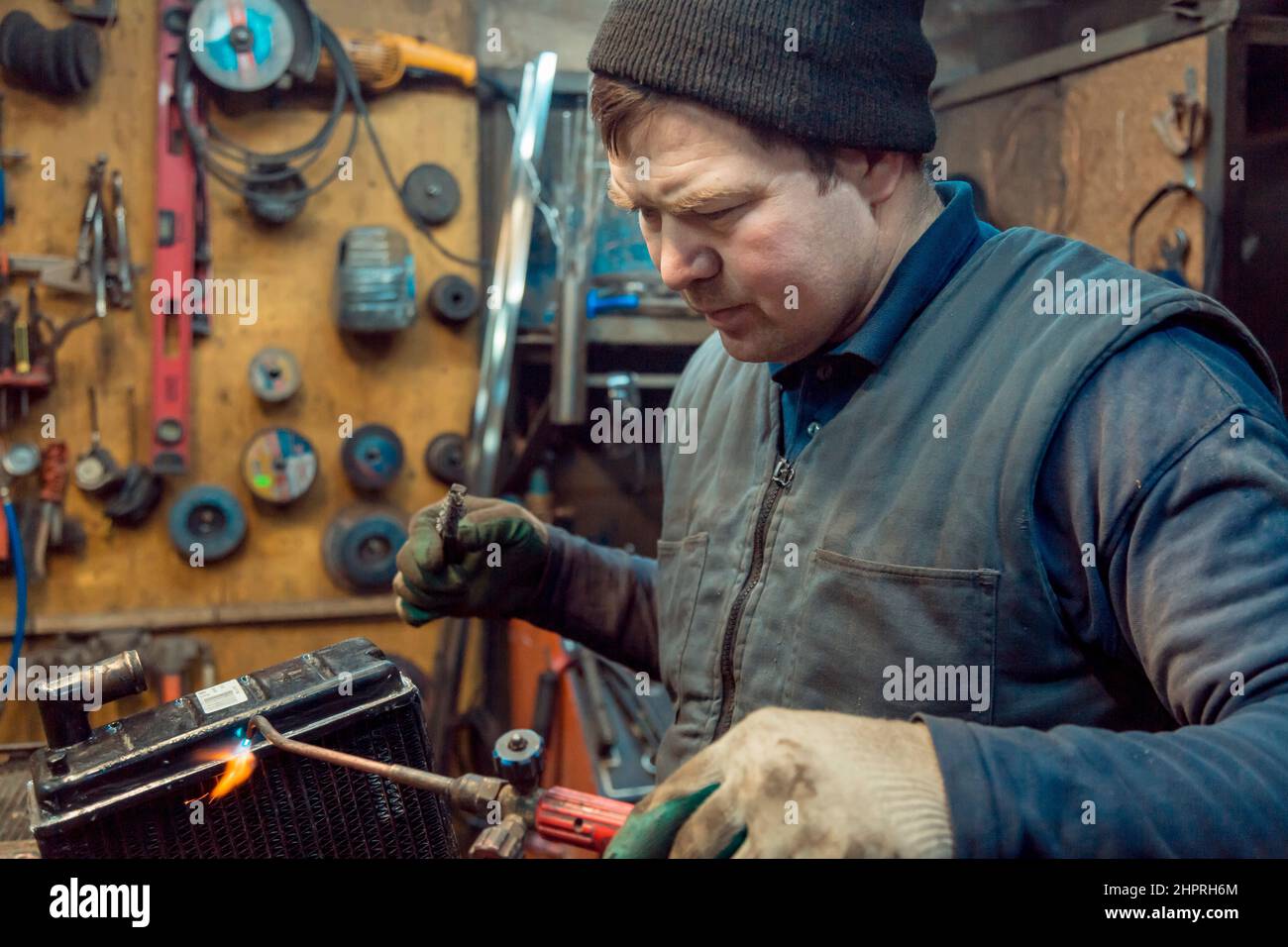 Welding a large car radiator with a gas torch Stock Photo - Alamy
