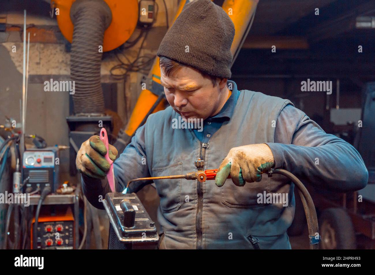 Welding a large car radiator with a gas torch Stock Photo - Alamy