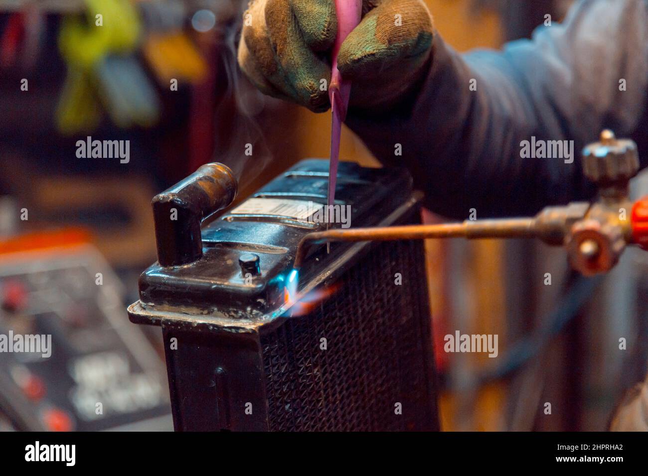 Welding a large car radiator with a gas torch Stock Photo - Alamy