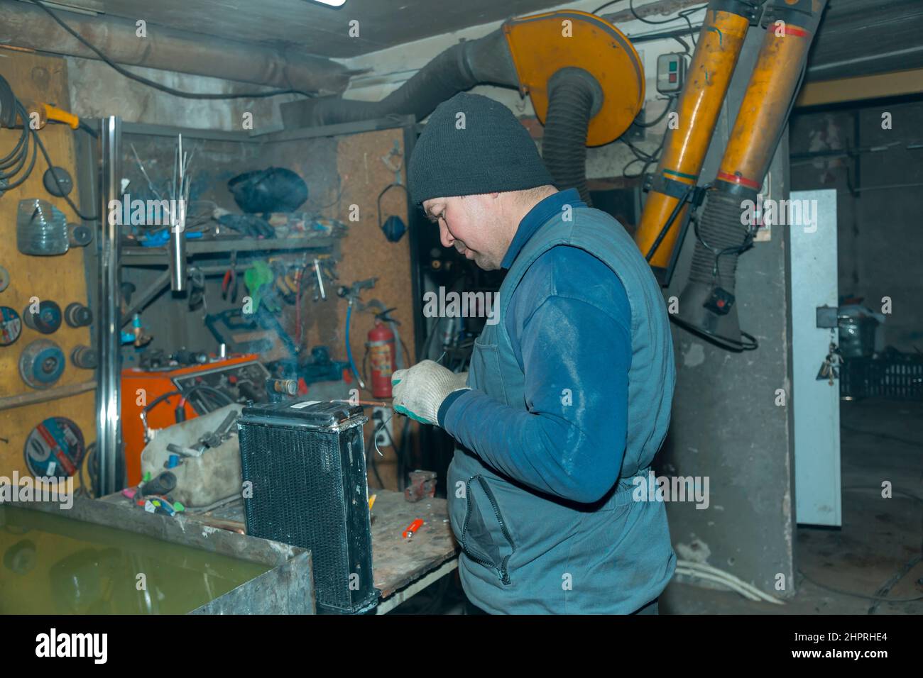 Welding a large car radiator with a gas torch Stock Photo - Alamy