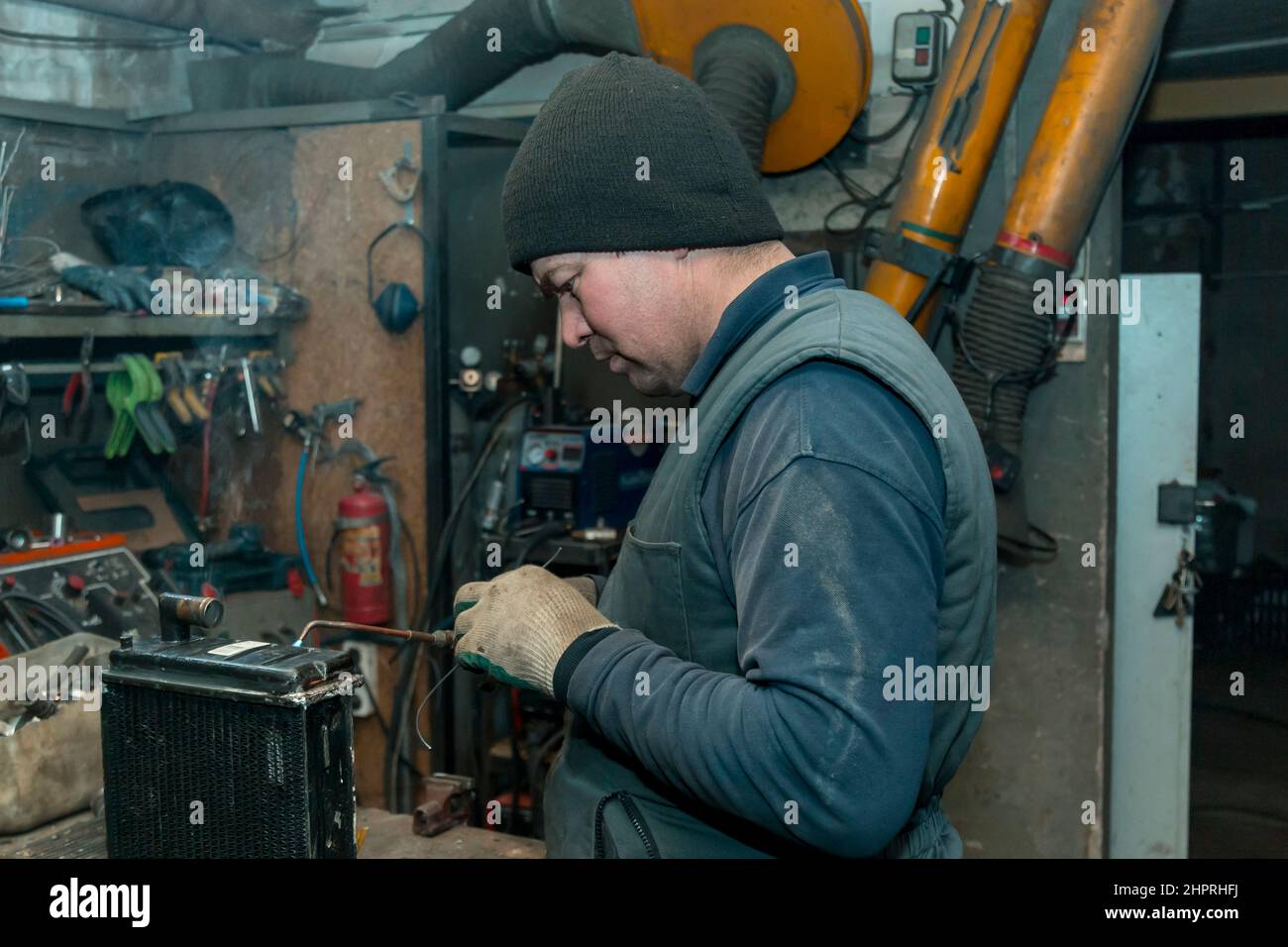 Welding a large car radiator with a gas torch Stock Photo - Alamy