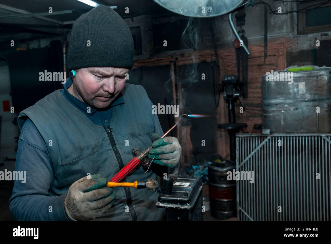 Welding a large car radiator with a gas torch Stock Photo - Alamy
