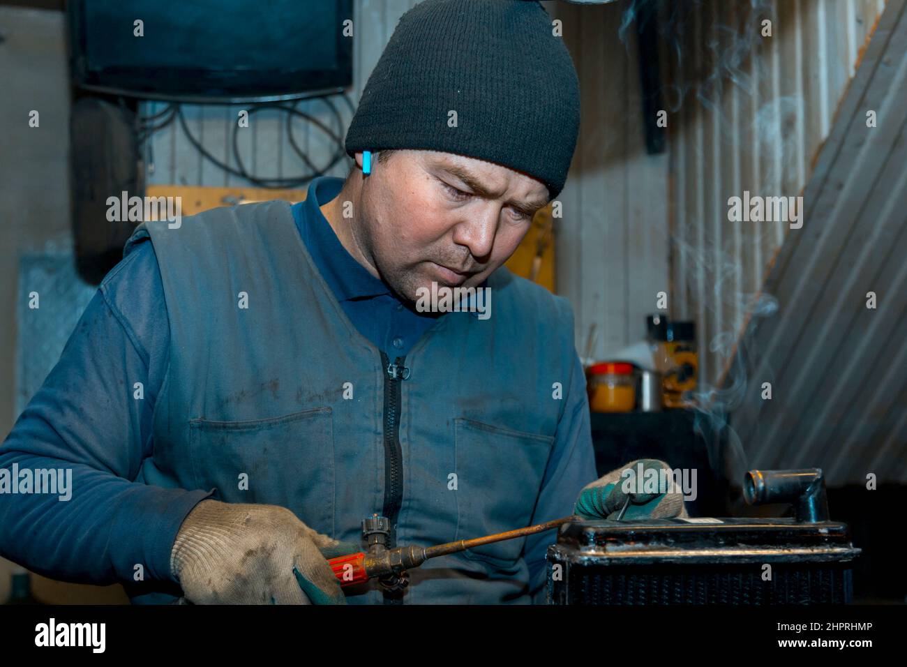 Welding a large car radiator with a gas torch Stock Photo - Alamy