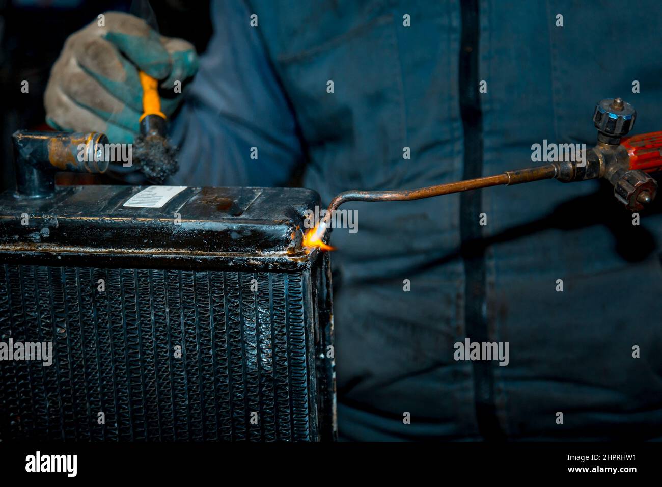 Welding a large car radiator with a gas torch Stock Photo - Alamy