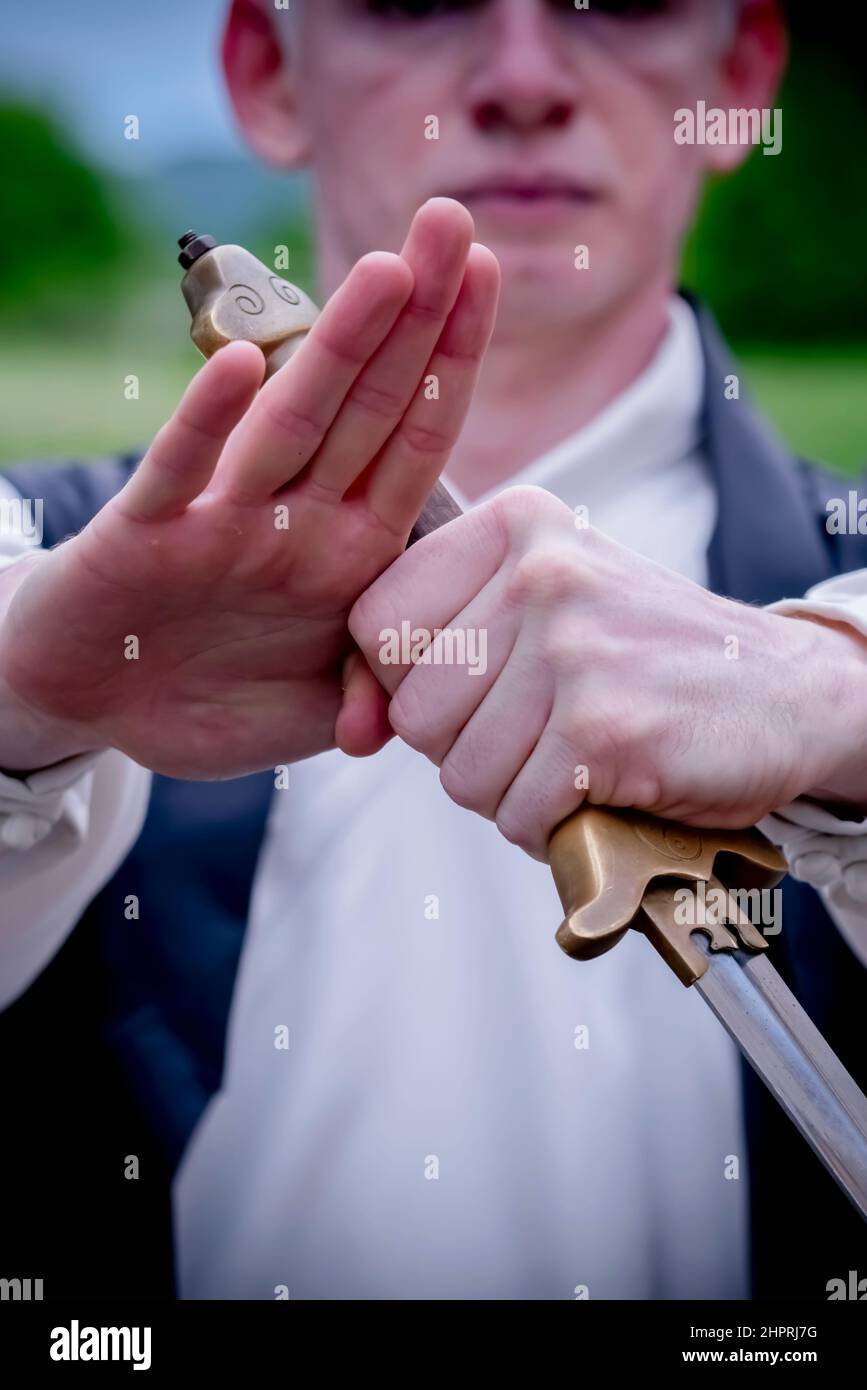 Kung Fu training. The man performs daily exercises with a sword ...