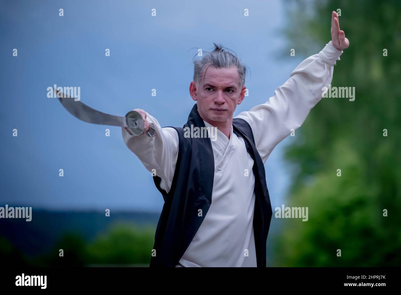 Kung Fu training. The man performs daily exercises with a sword Stock ...