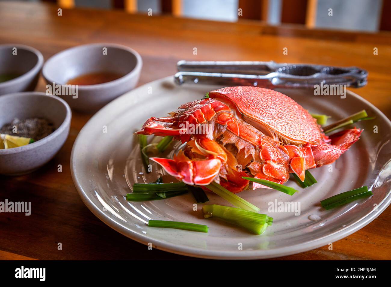 One big red crab on a white plate at a seafood restaurant in Quy Nhon ...