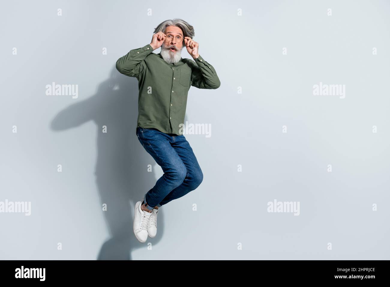 Photo of impressed man pensioner dressed khaki shirt arms hands ...