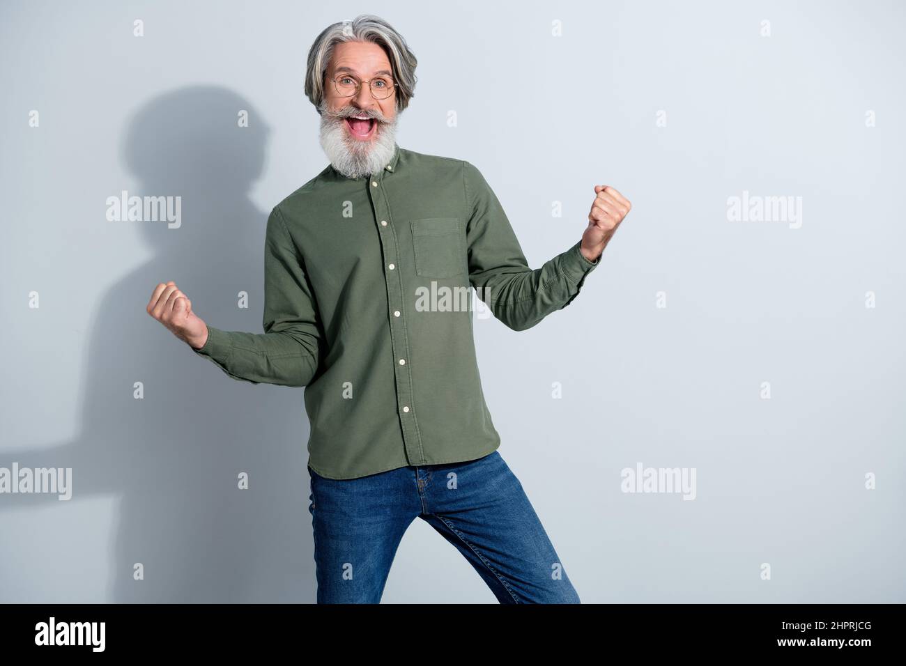 Photo of lucky man pensioner dressed khaki shirt shouting rising fists ...