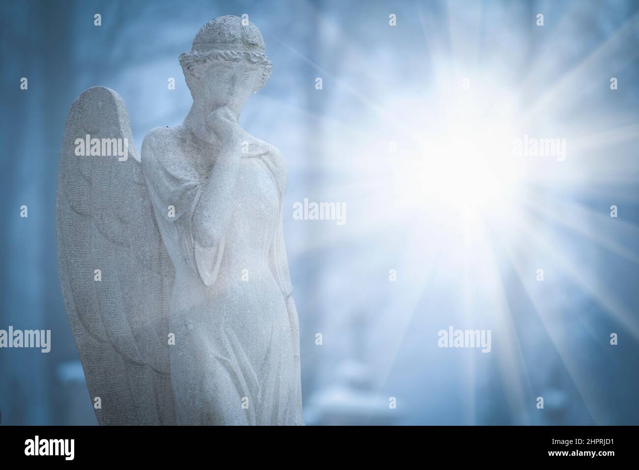 Dramatic sensitive facial expression of beautiful angel in the rays of ...