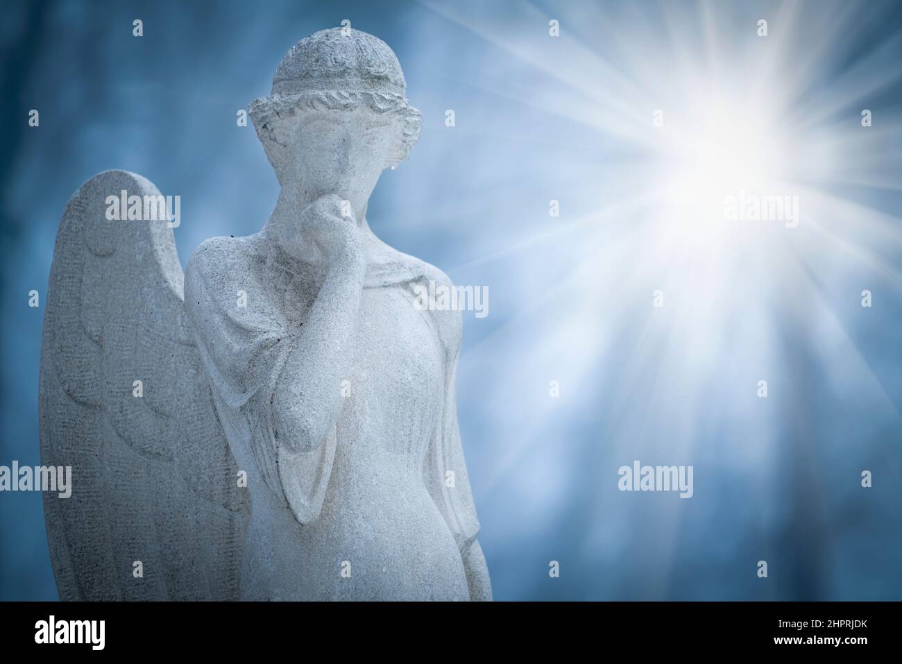 Dramatic sensitive facial expression of beautiful angel in the rays of ...