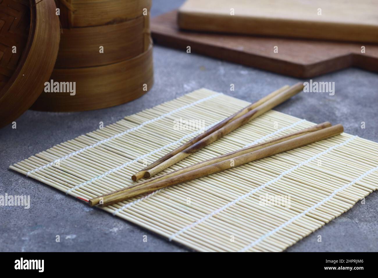 Sushi Roller mat on grey grainy background Stock Photo - Alamy