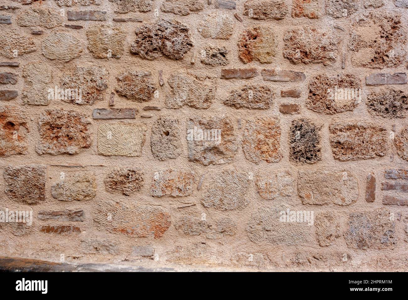 Old masonry from blocks of different sizes in cement mortar Stock Photo ...