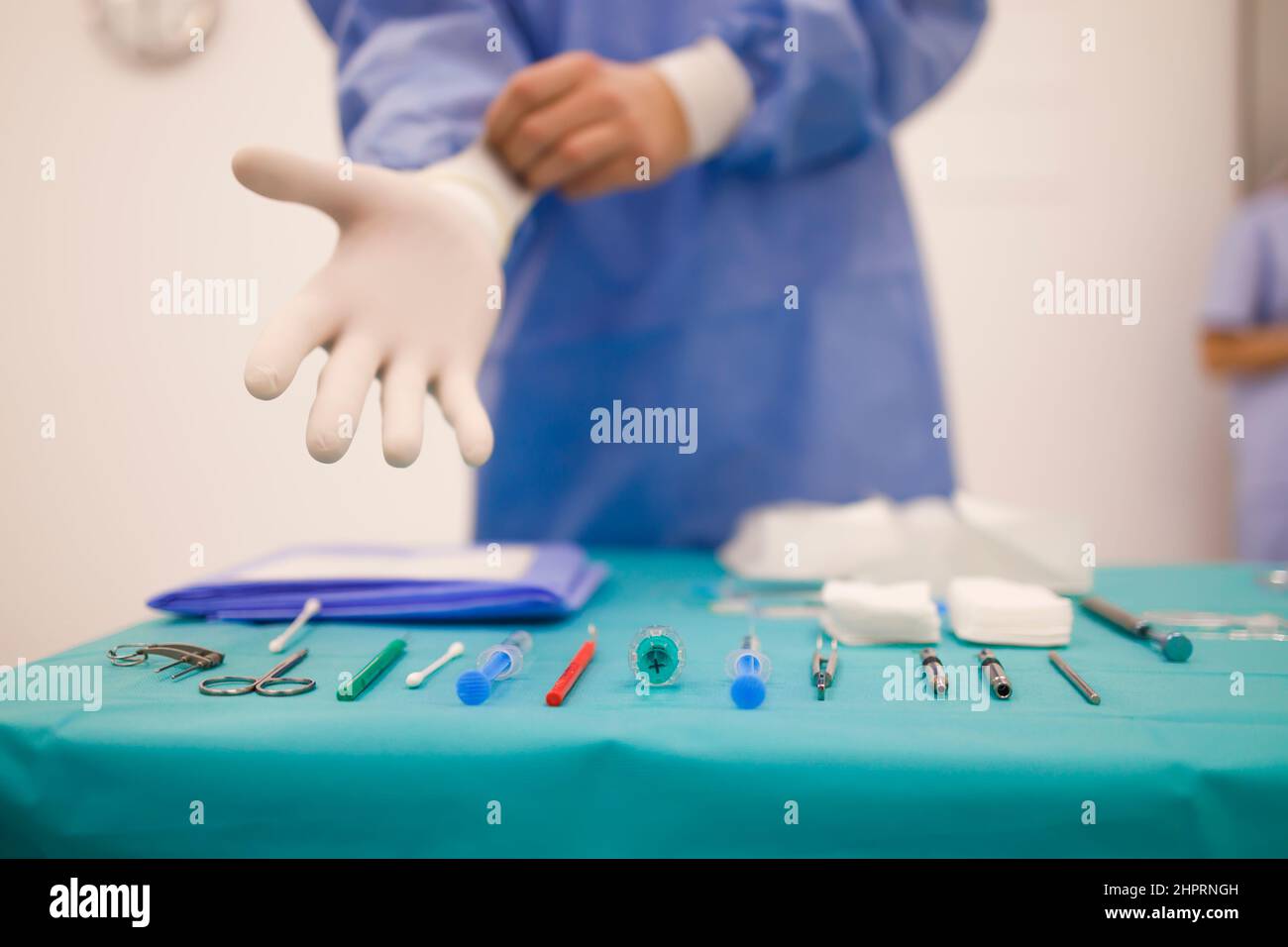 Doctor preparing for a surgery with his instruments in front of him ...