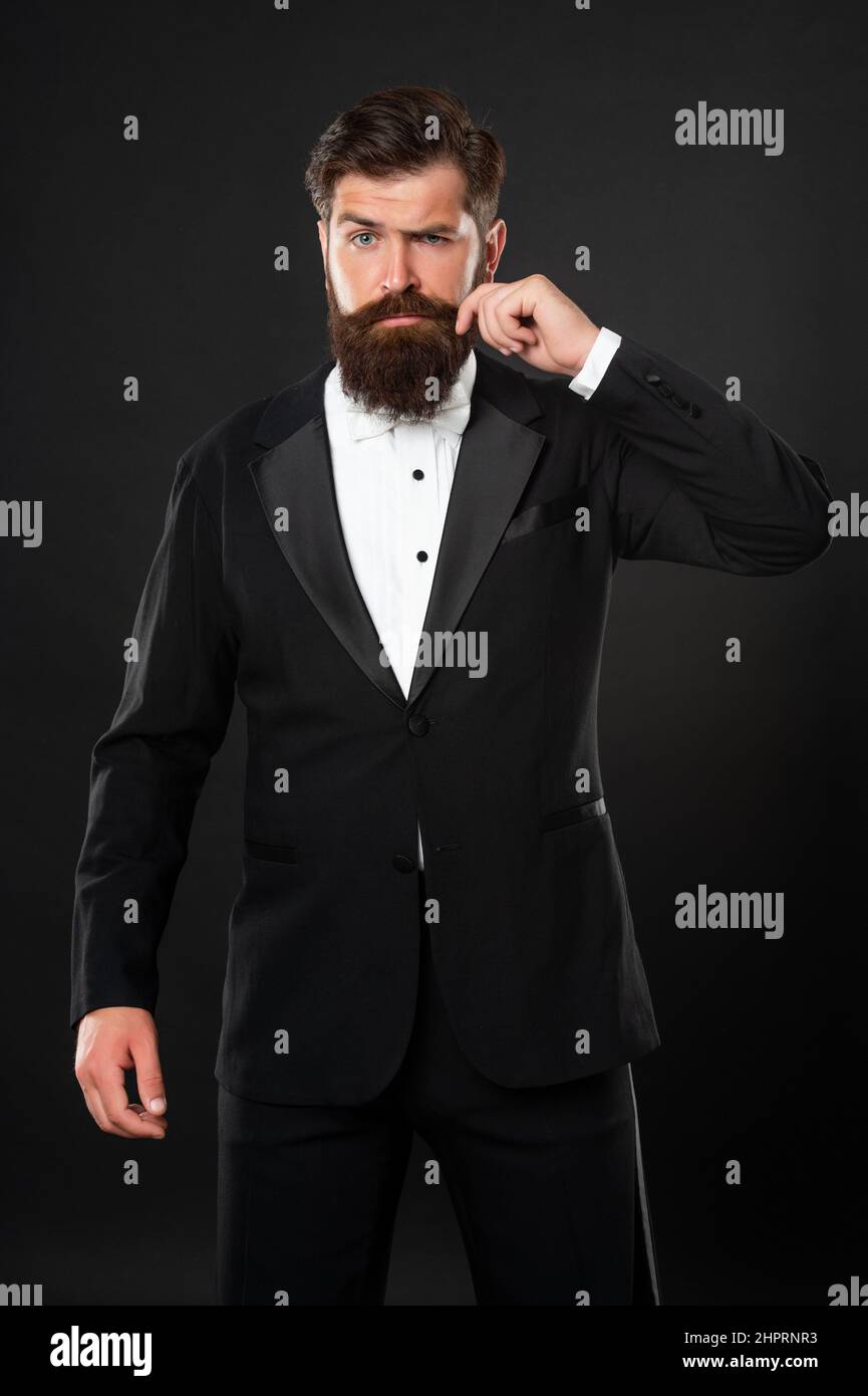 elegant butler in tuxedo on black background, menswear Stock Photo - Alamy