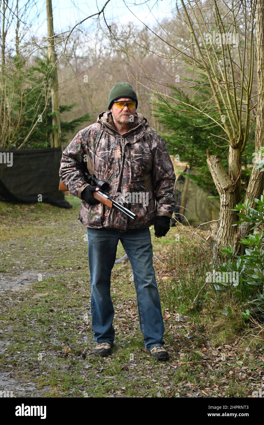 A hunter with a hunting rifle in the UK Stock Photo - Alamy