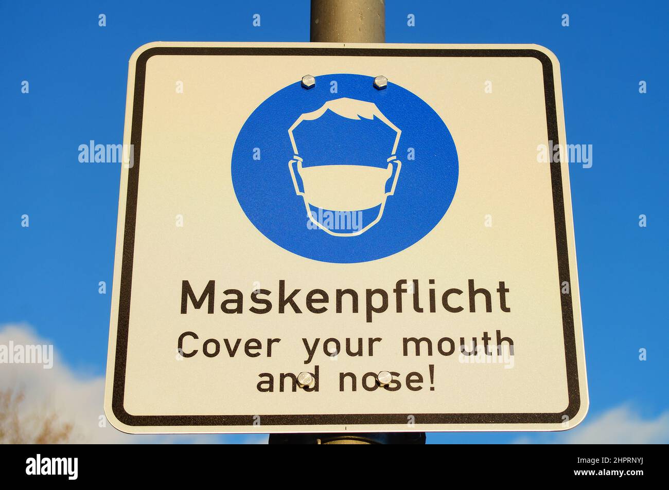 A sign indicates the obligation to wear a mask Stock Photo - Alamy