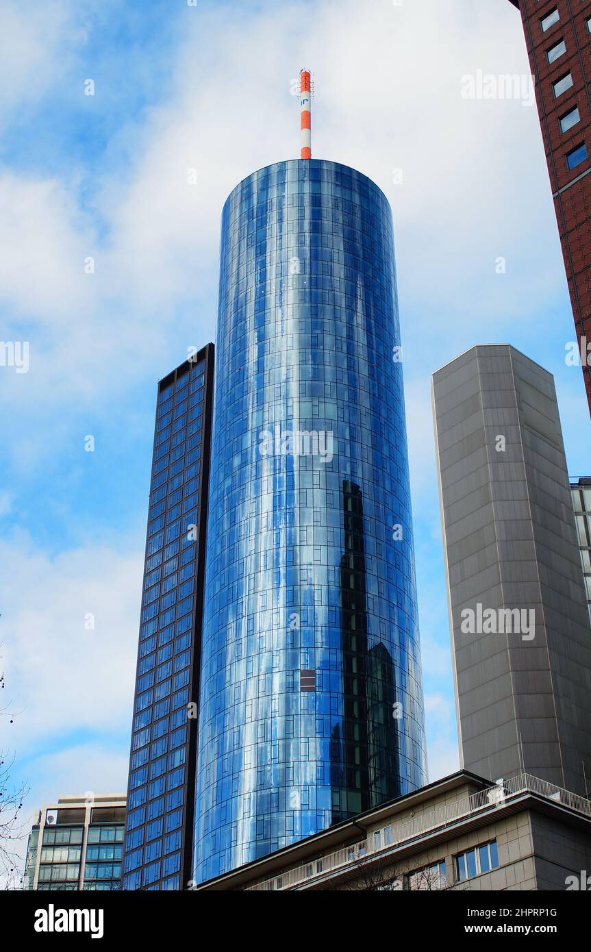 The MAIN TOWER in Frankfurt reflects the cloudy blue evening sky in ...