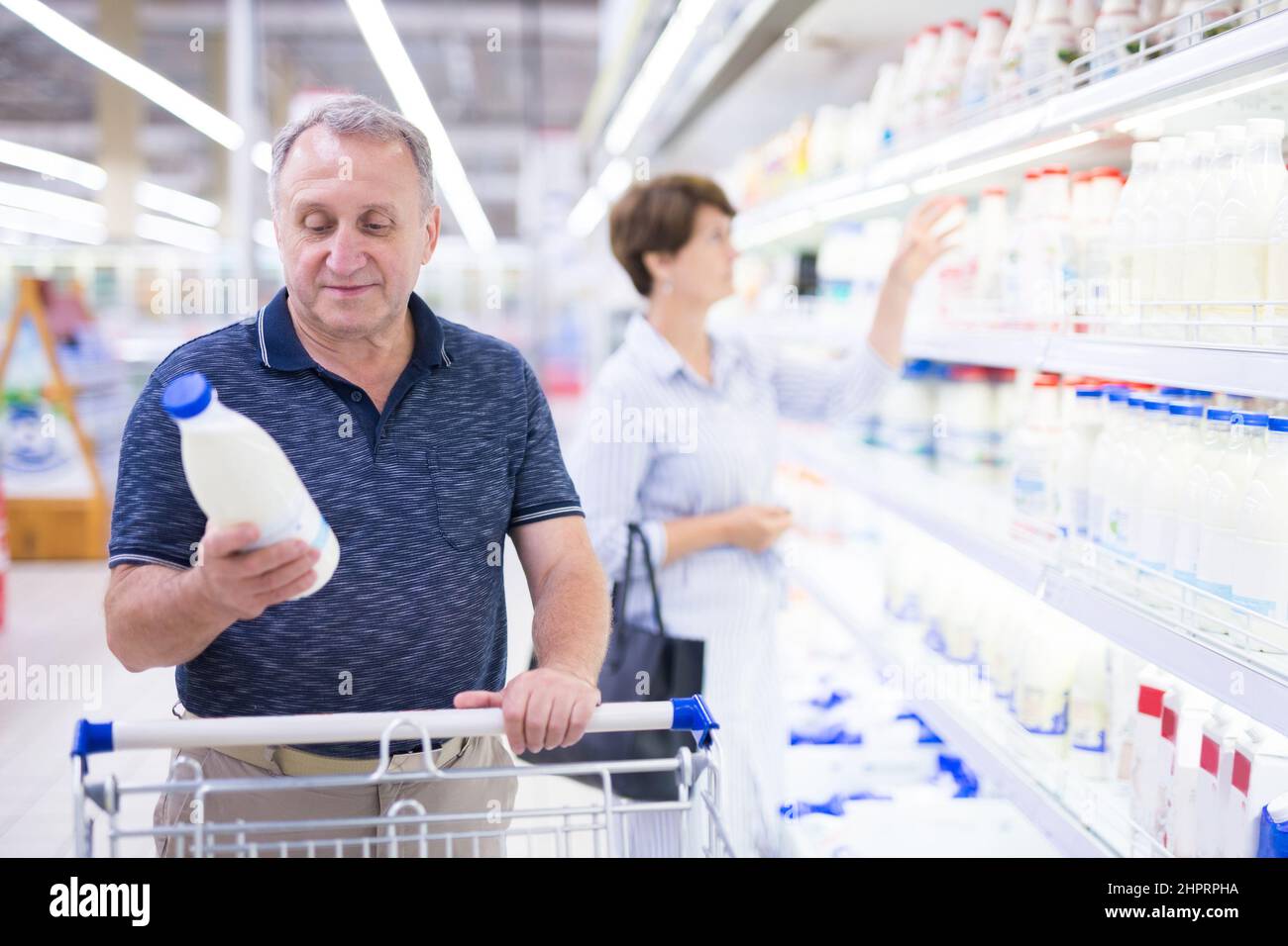 mature man choosing milk in supermarket Stock Photo - Alamy