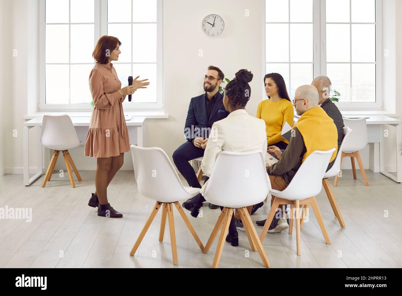 Female leader head training with employees Stock Photo - Alamy