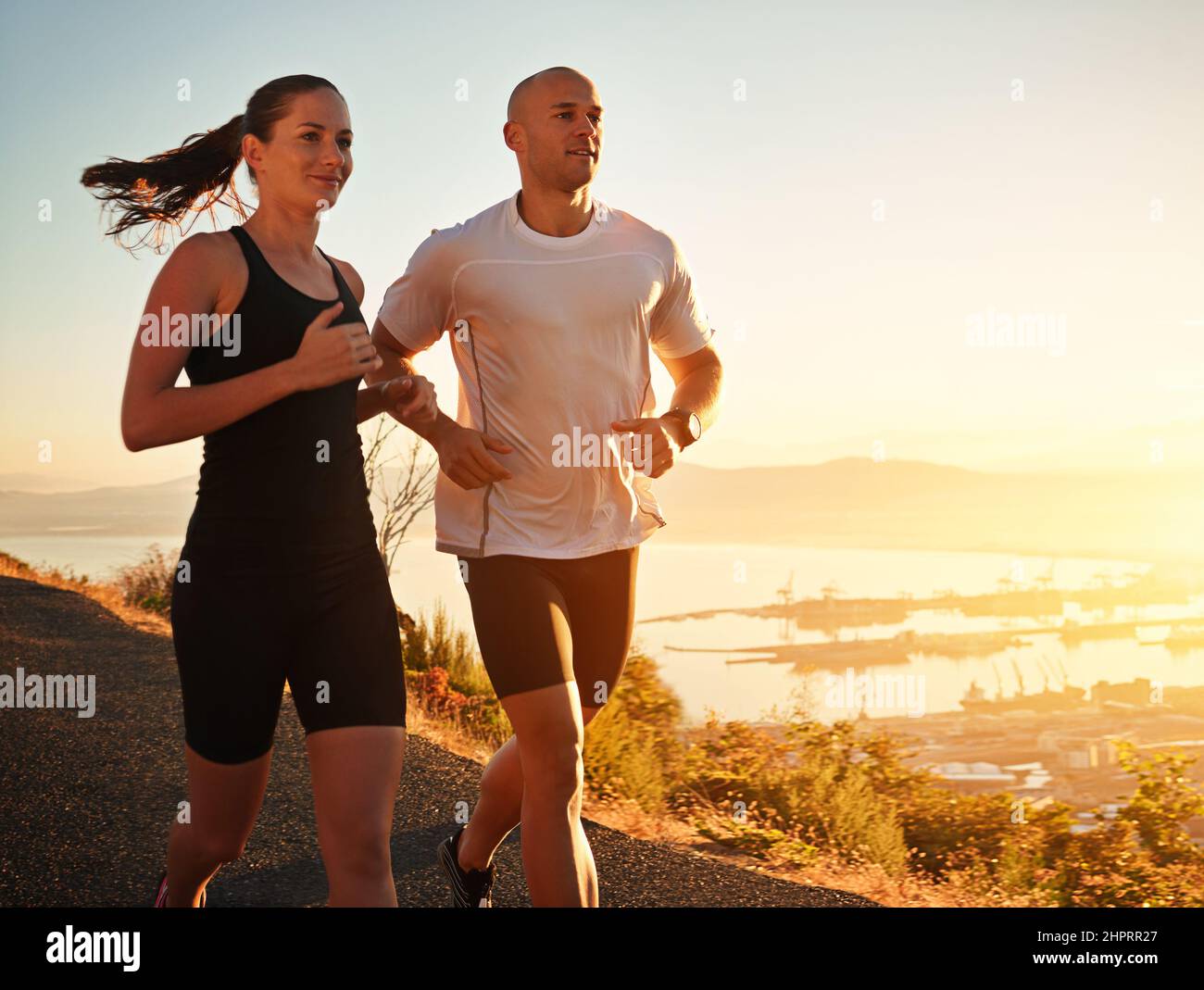 Running is part of their daily routine. Shot of a young couple running ...