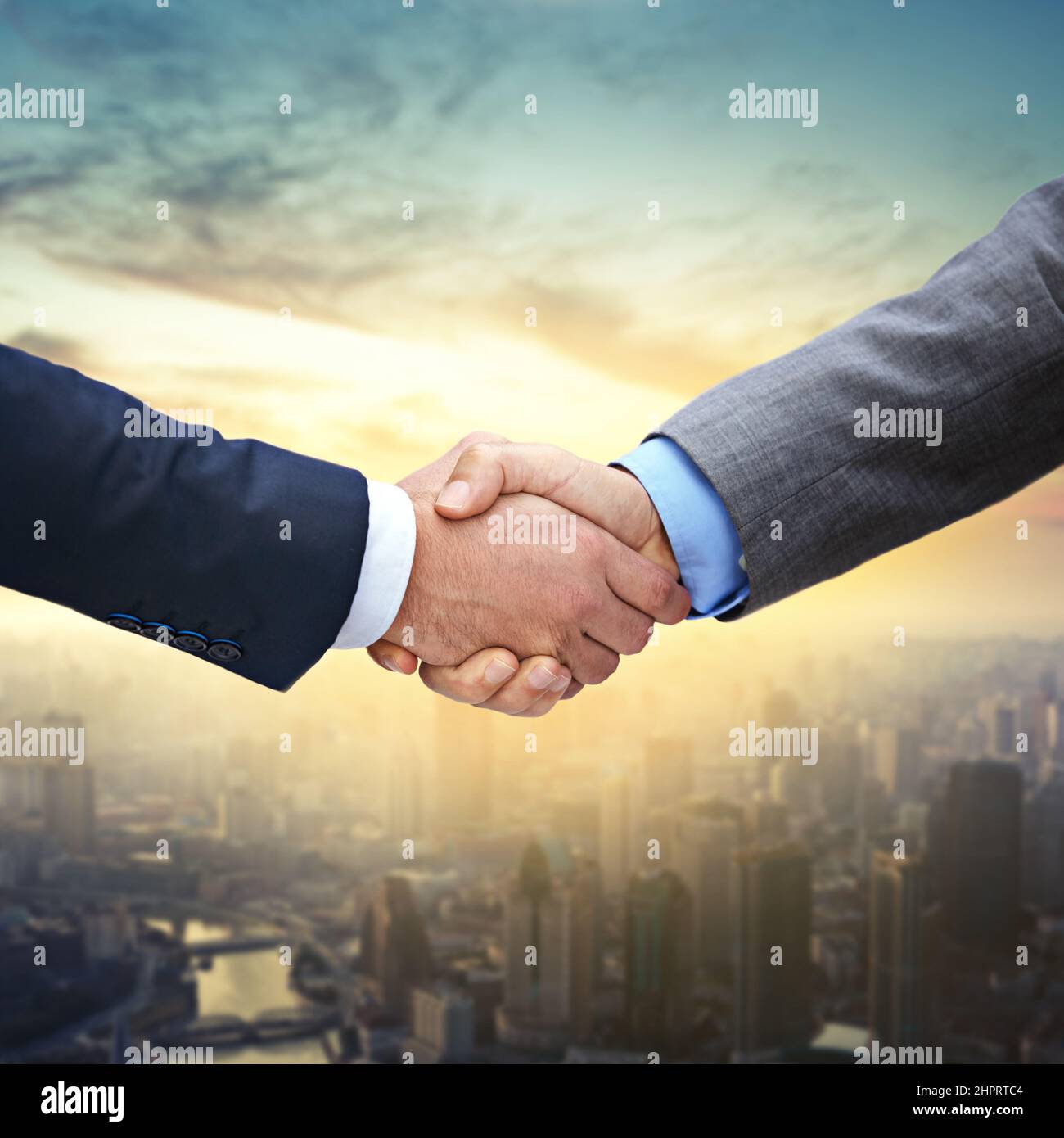 Taking the city by storm. Shot of two businessmen shaking hands Stock ...