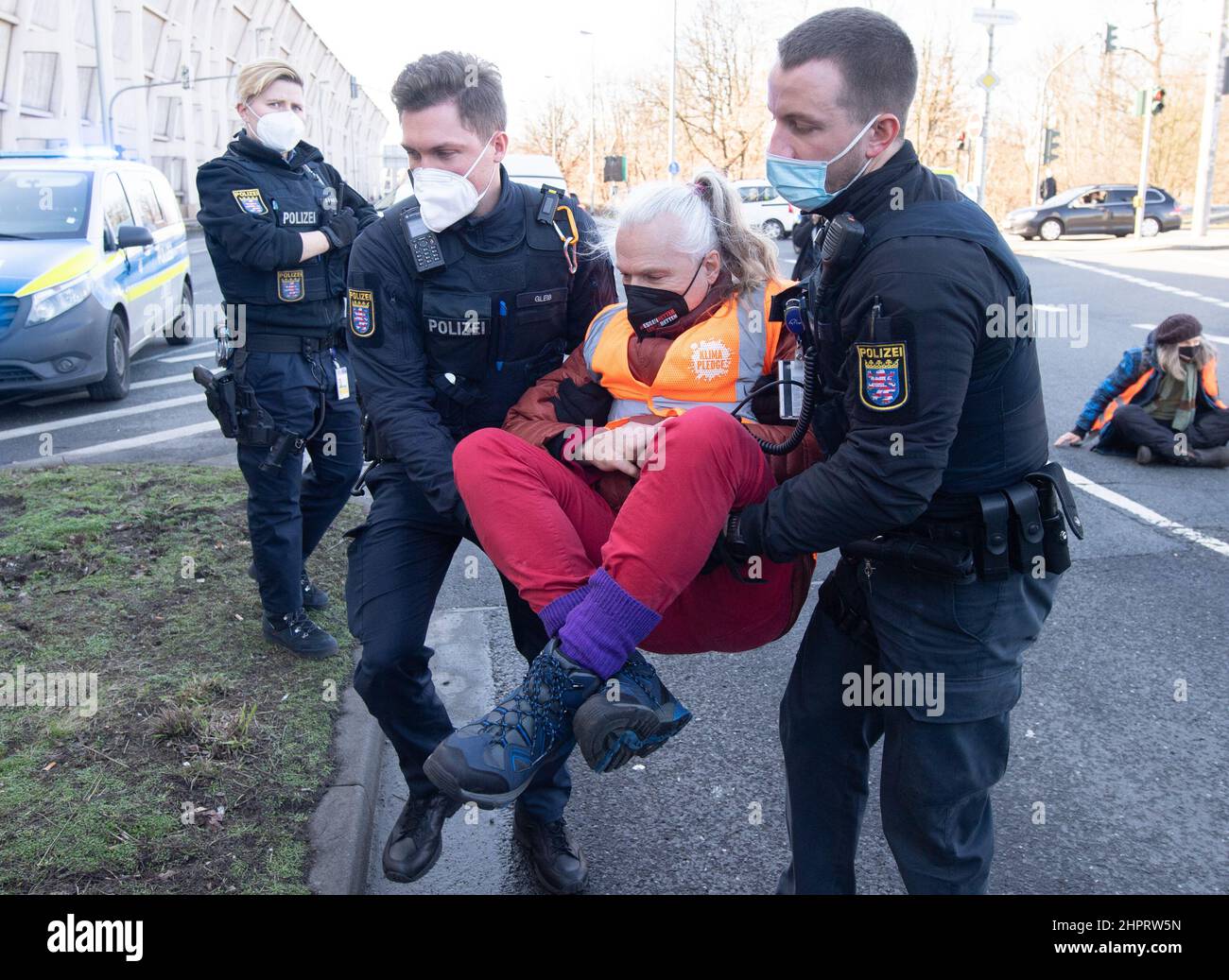 23 February 2022, Hessen, Frankfurt/Main: Police officers carry an ...