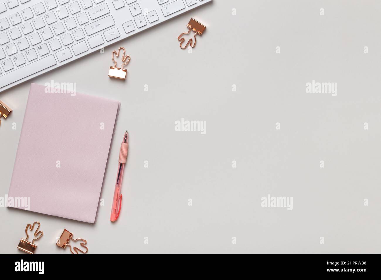 Desktop. Notepad keyboard pen paper clips on the table. Top view flat ...