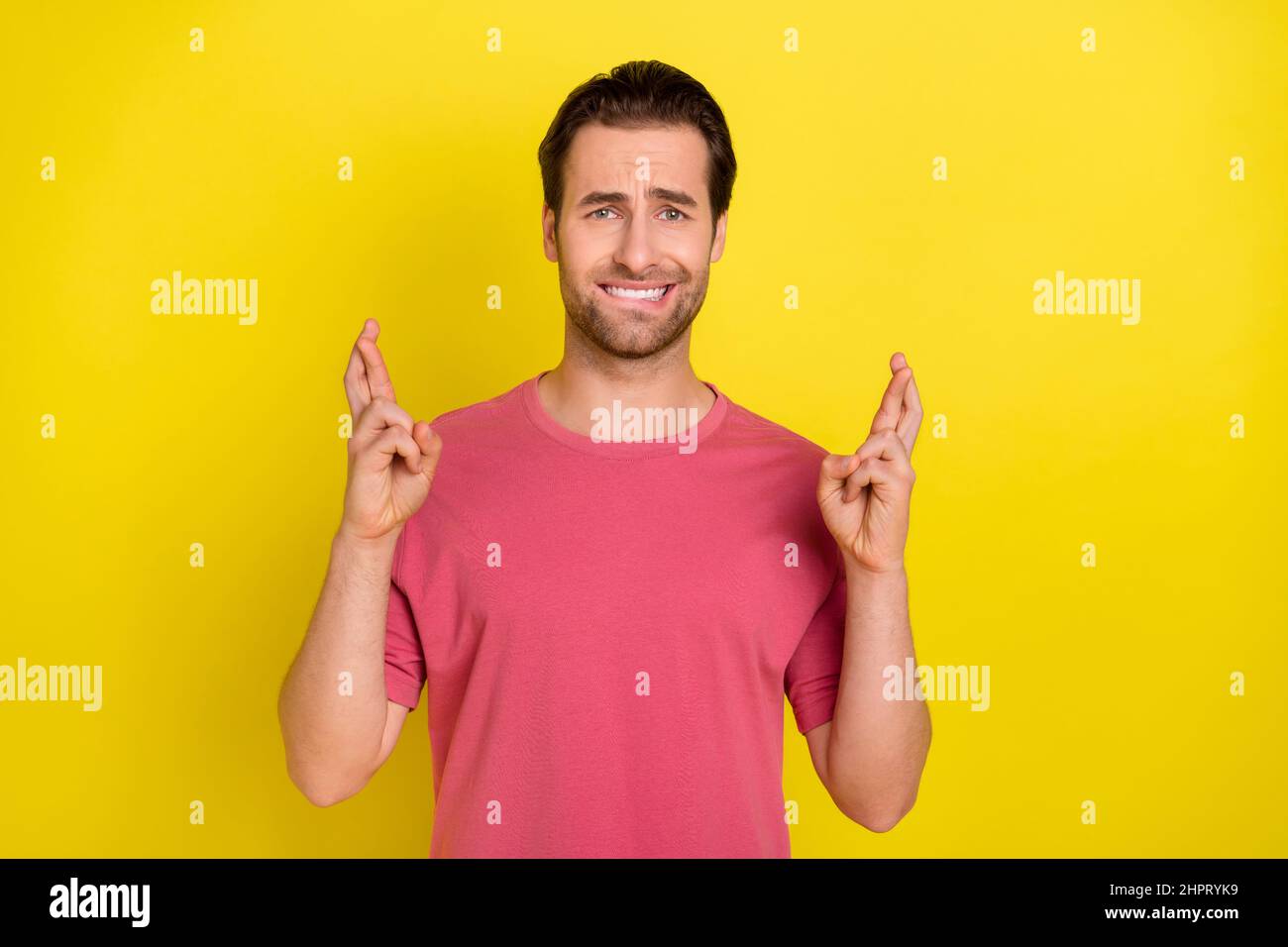 Photo of anxious frightened terrified guy crossed fingers bite lip wear ...