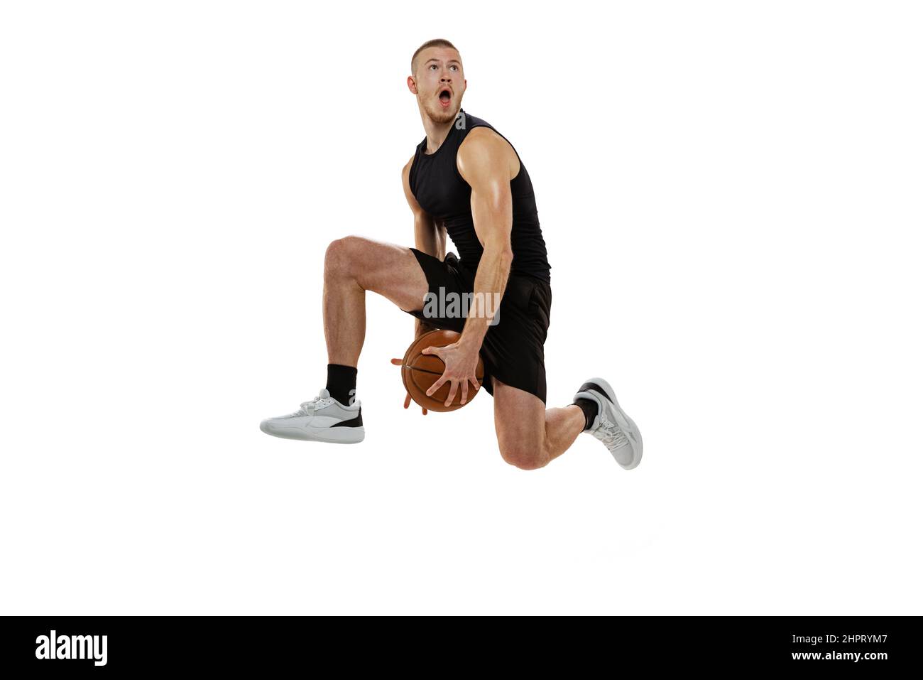 Dynamic portrait of basketball player jumping with ball isolated on ...