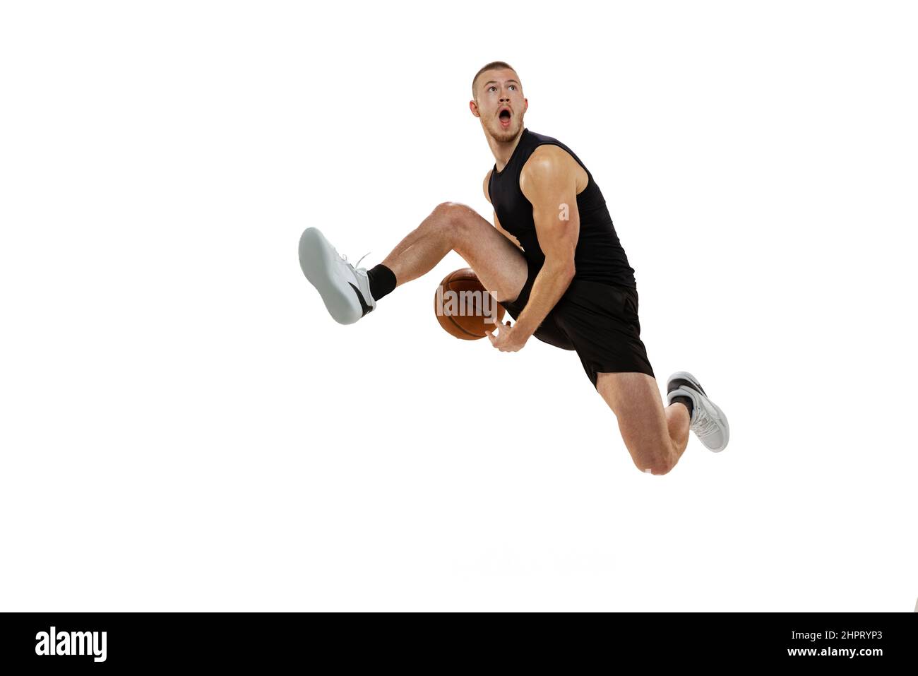 Dynamic portrait of basketball player jumping with ball isolated on ...