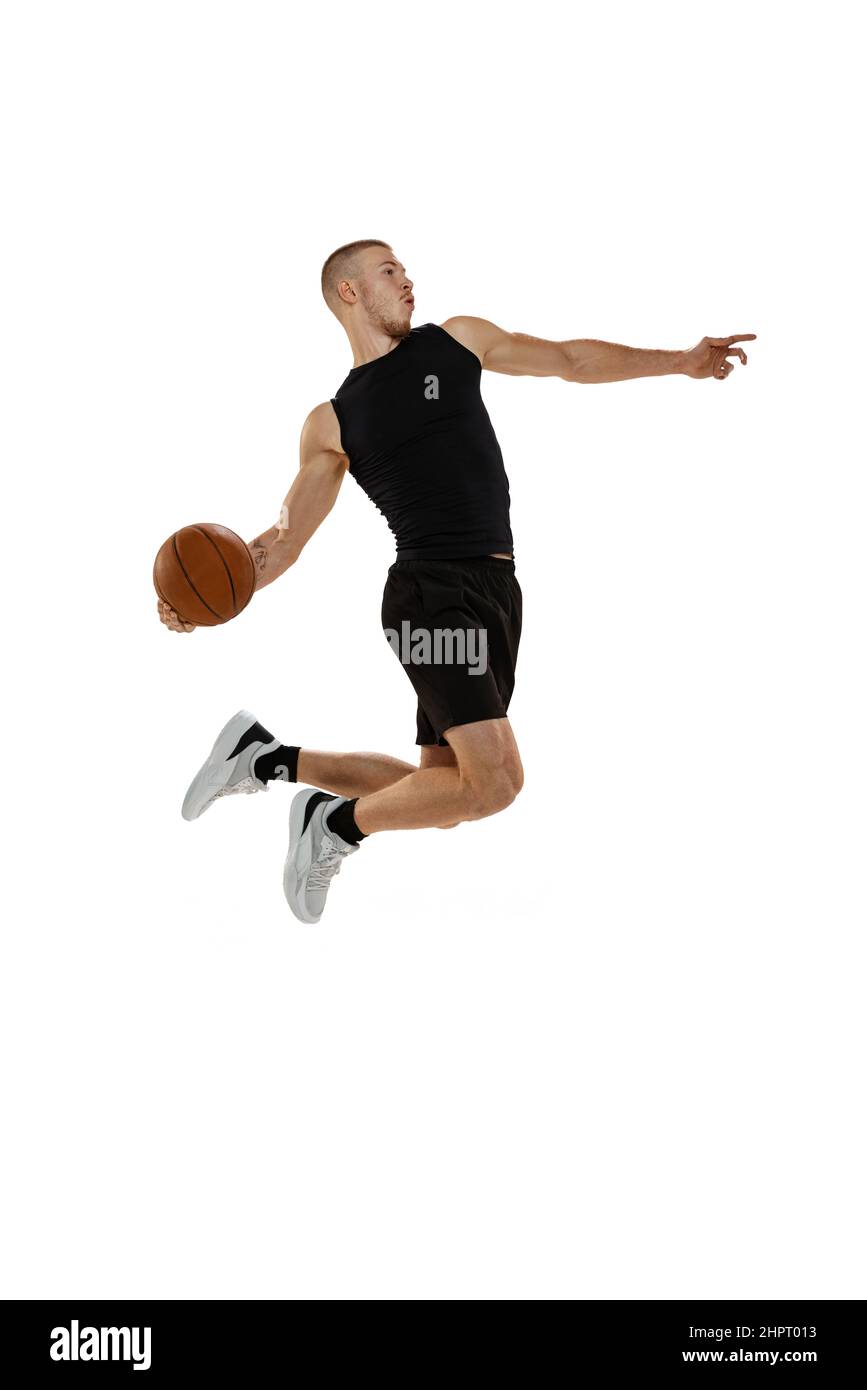 Dynamic portrait of basketball player jumping with ball isolated on ...