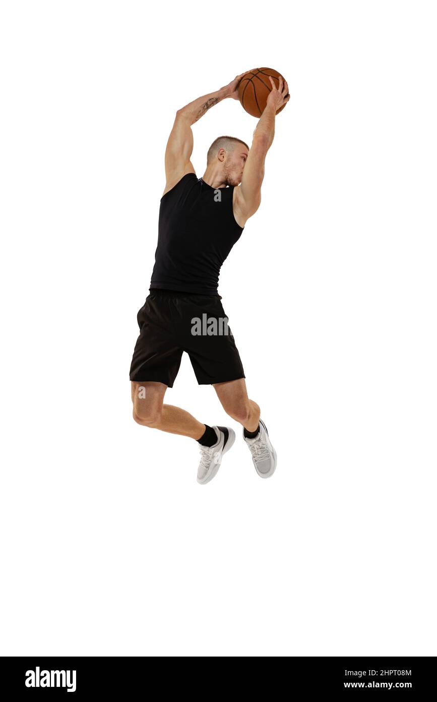 Dynamic portrait of basketball player jumping with ball isolated on ...