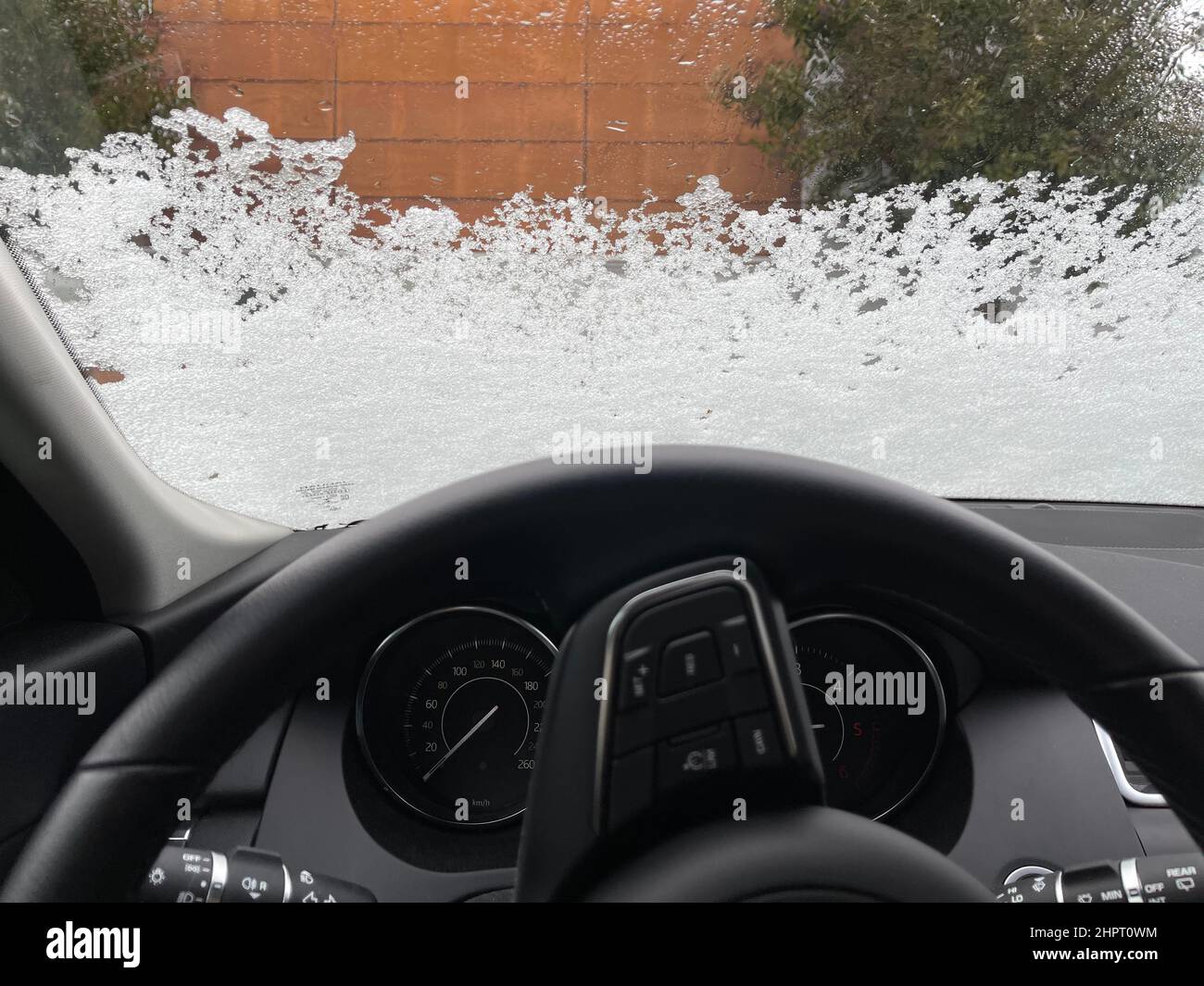 A heavy covered car with snow showing the inside of a car from outside ...