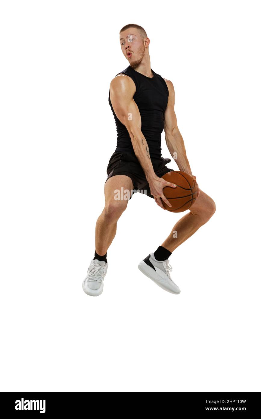 Dynamic portrait of muscled man, basketball player jumping with ball ...