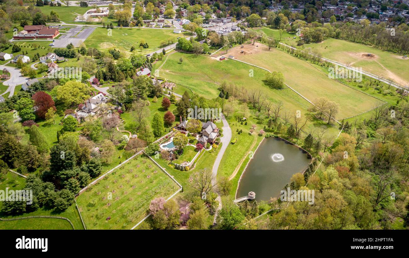 Aerial View of Countryside of Homes With a Pond and Fountain Viewed by ...