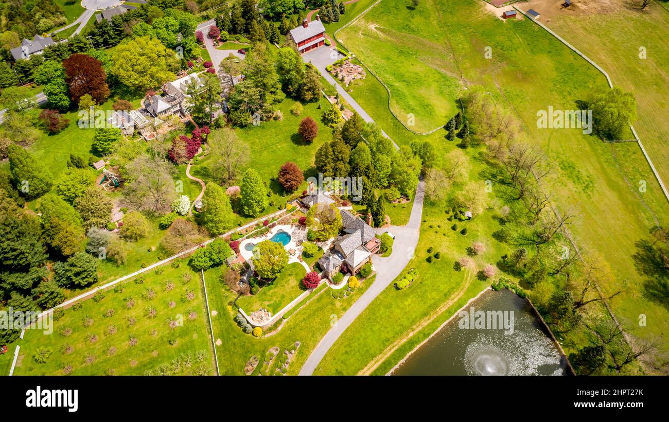 Aerial View of Countryside of Homes With a Pond and Fountain Viewed by ...