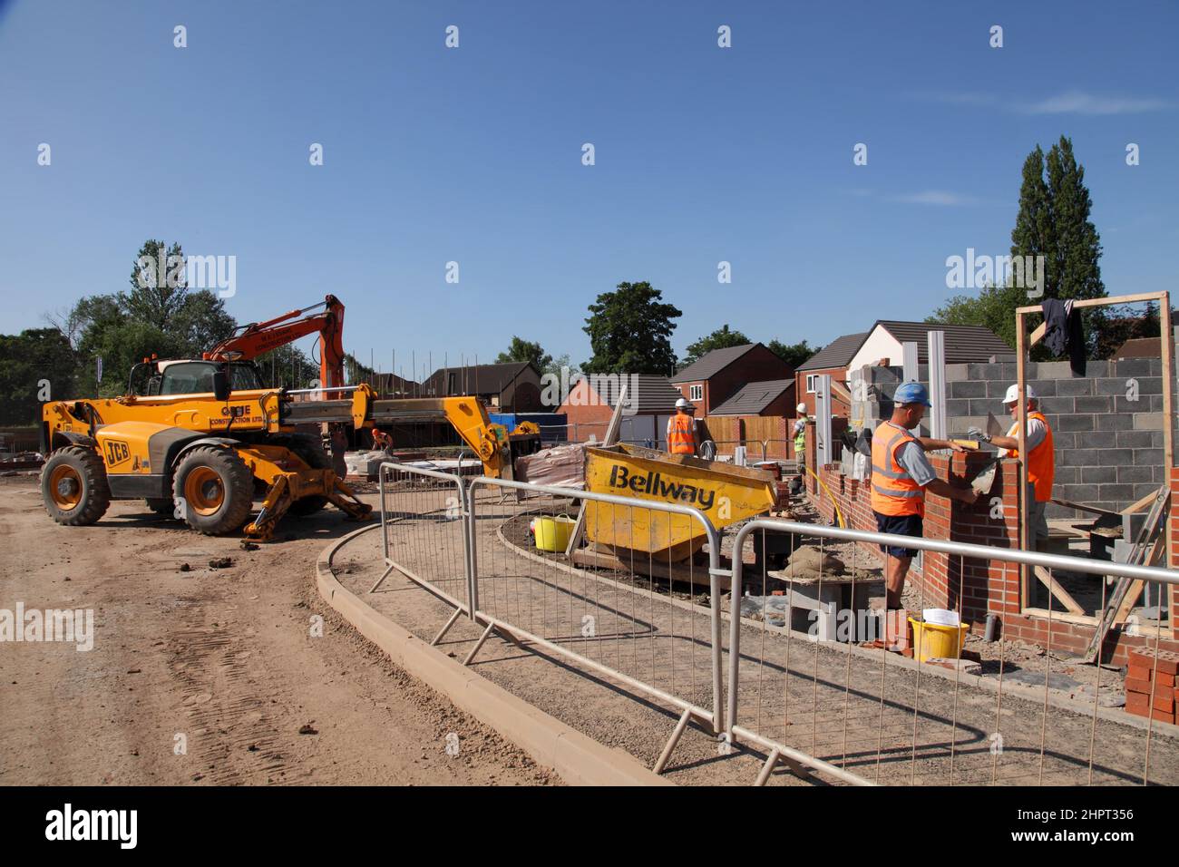 Builders and brick layers at work on a Bellway Homes construction site ...
