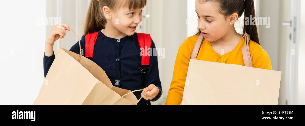two schoolgirls with delivery packages Stock Photo - Alamy