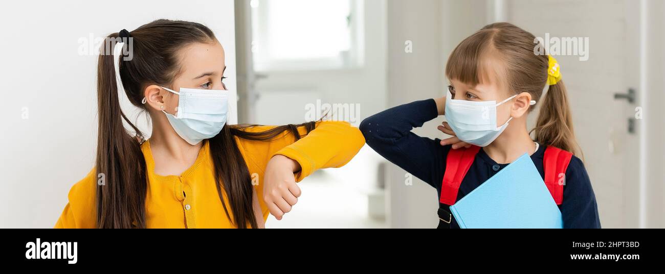 Close-up portrait of two nice attractive girls wearing safety mask ...