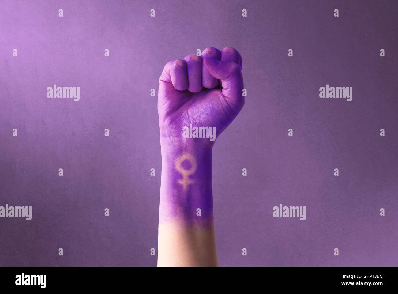 Raised purple fist of a woman for international women's day and the ...