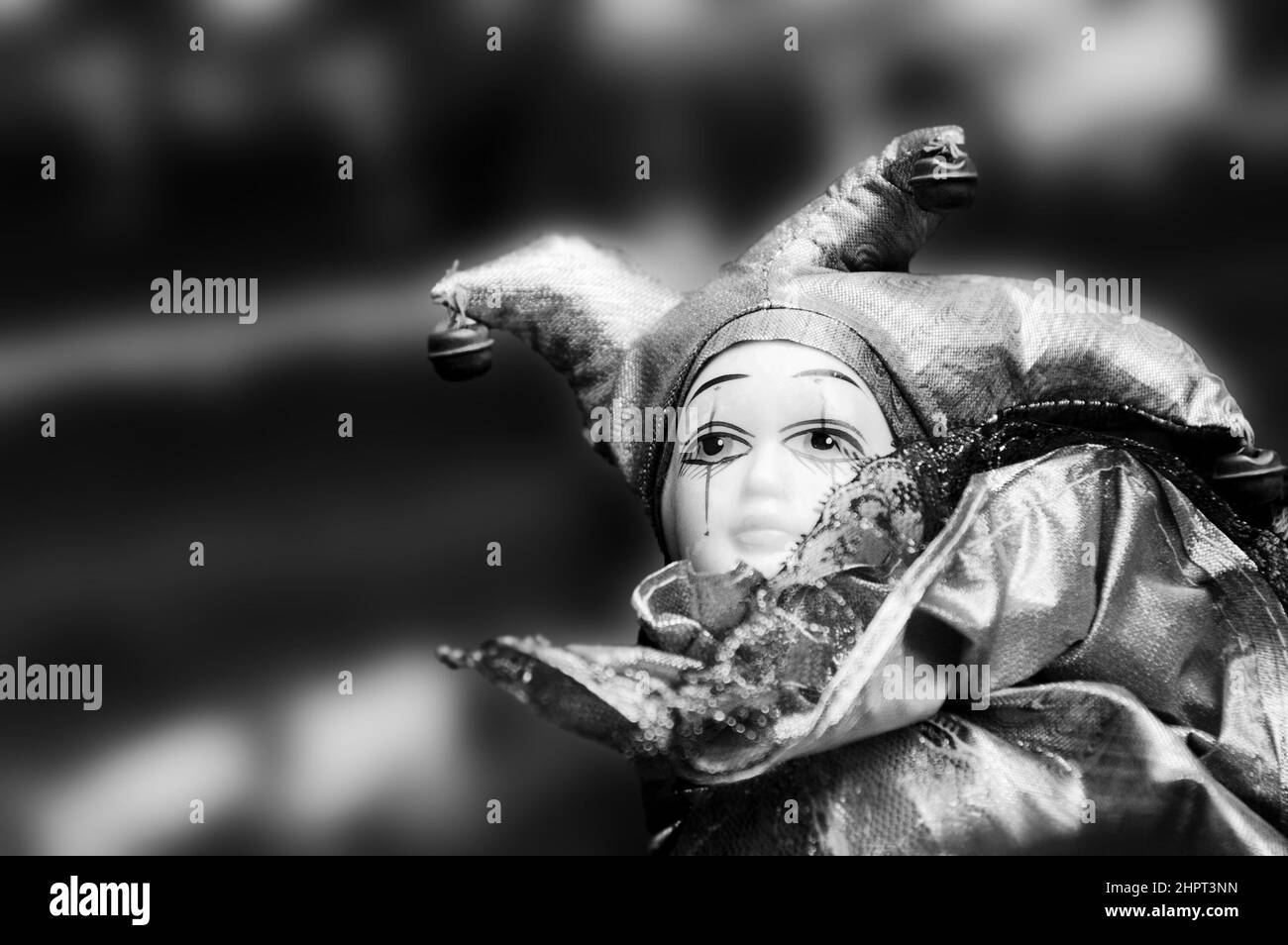 Vintage sad clown puppet on blurred background. Black and white Stock ...