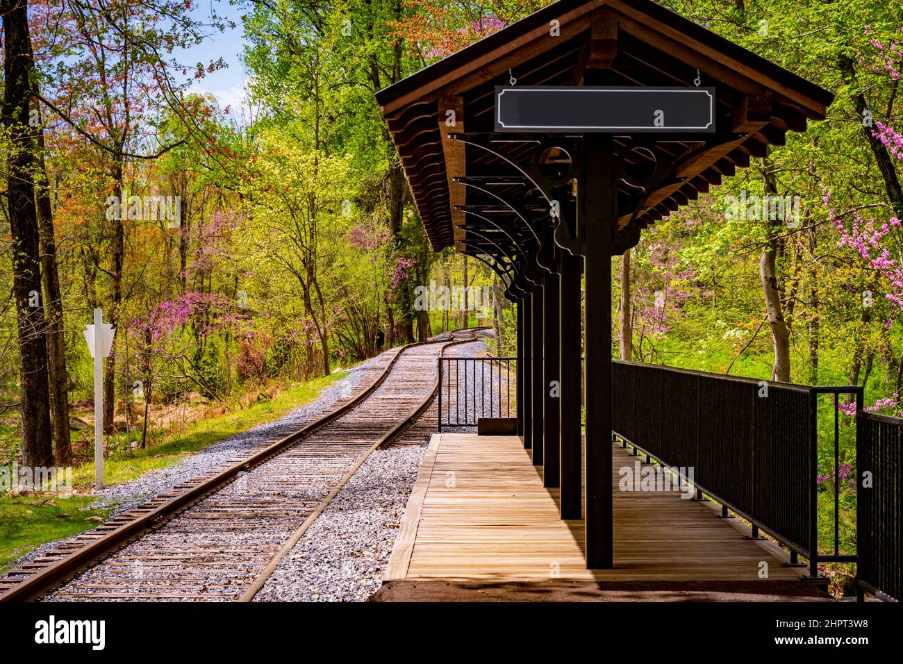 A Lonely Train Station in the Woods With a Stream and Stone Wall by a ...
